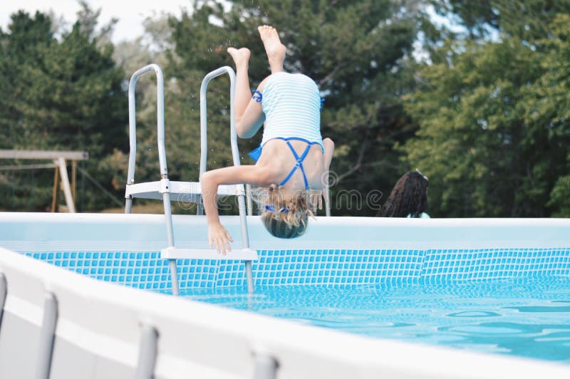 Young Female Doing a Back Flip into a Pool Stock Photo - Image of ...