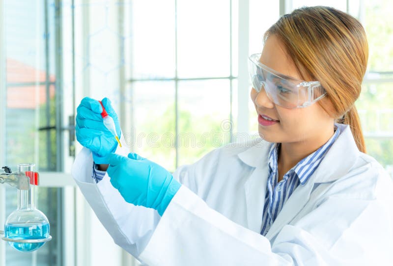 Young Female Doing Experiments and Researchers Working in the ...