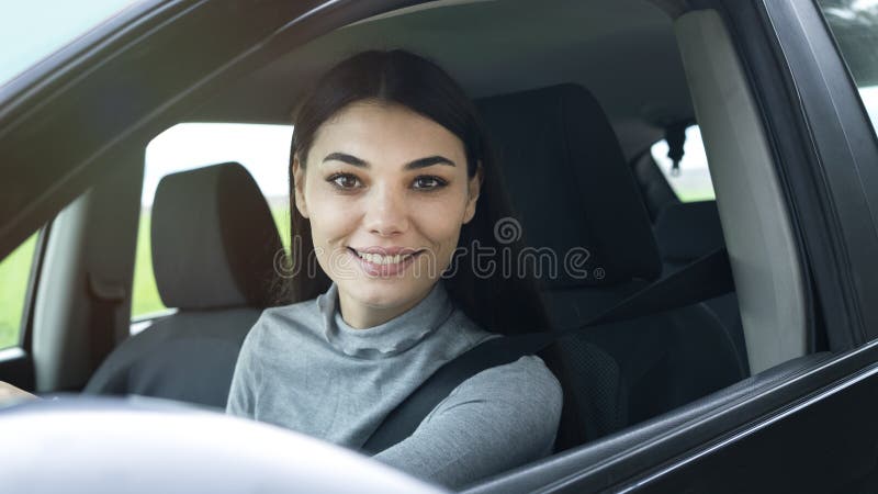 Young Female Driver Sitting in a Car and Looking at Camera Stock Image ...