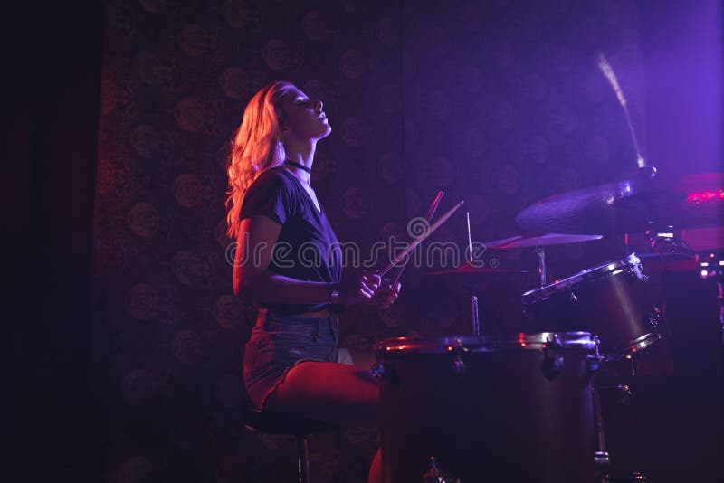 Young Female Drummer Performing in Illuminated Nightclub Stock Image ...