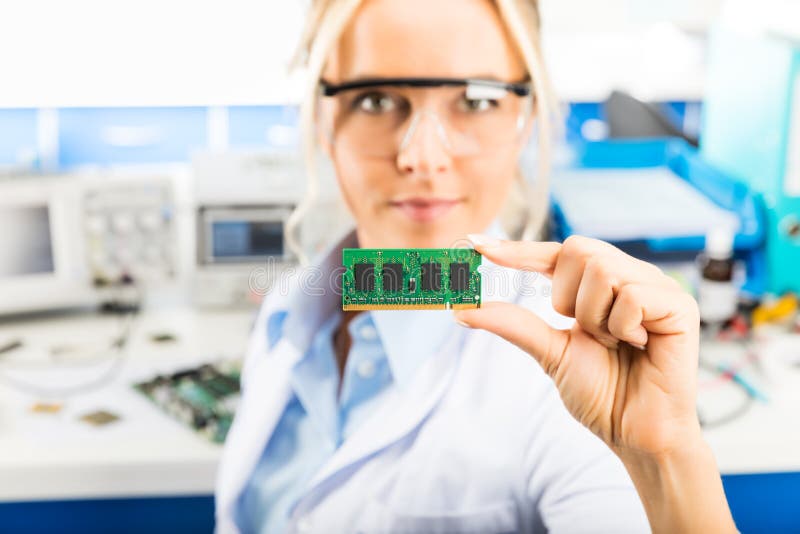 Female Electronic Engineer Checking Circuit Board in Laboratory Stock ...