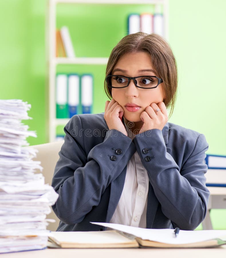Young Female Employee Very Busy with Ongoing Paperwork Stock Photo ...