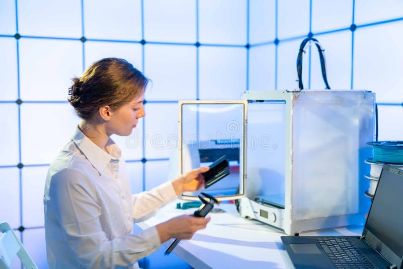 Young Female Engineer in a Laboratory Researching 3D Printing ...