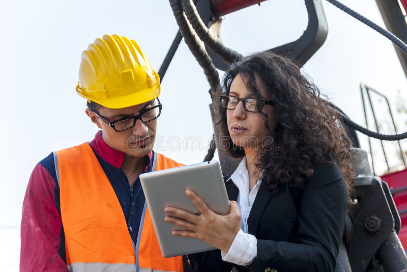 Young Female Engineer Talks about Working Stock Photo - Image of collar ...