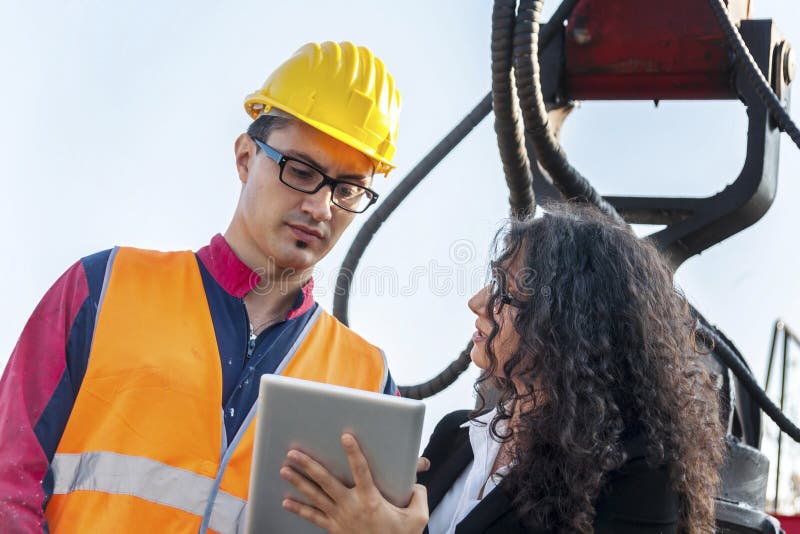 Young Female Engineer Talks about Working Stock Photo - Image of collar ...