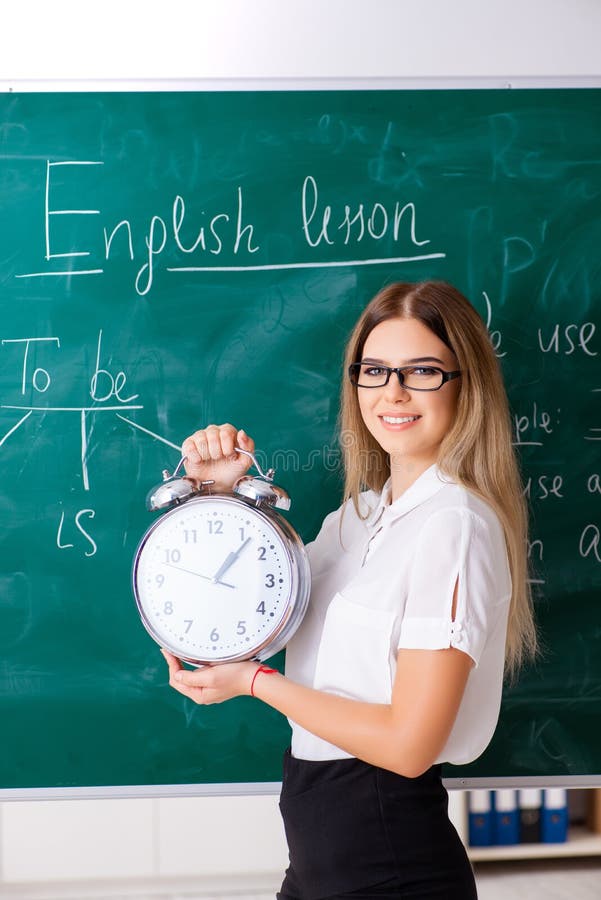 The Young Female English Language Teacher Standing in Front of the ...
