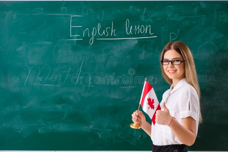 The Young Female English Language Teacher Standing in Front of the ...