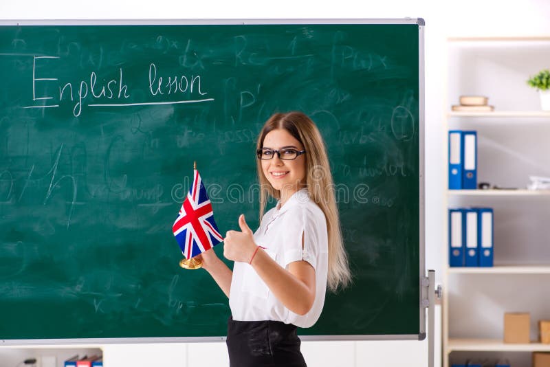 The Young Female English Language Teacher Standing in Front of the ...
