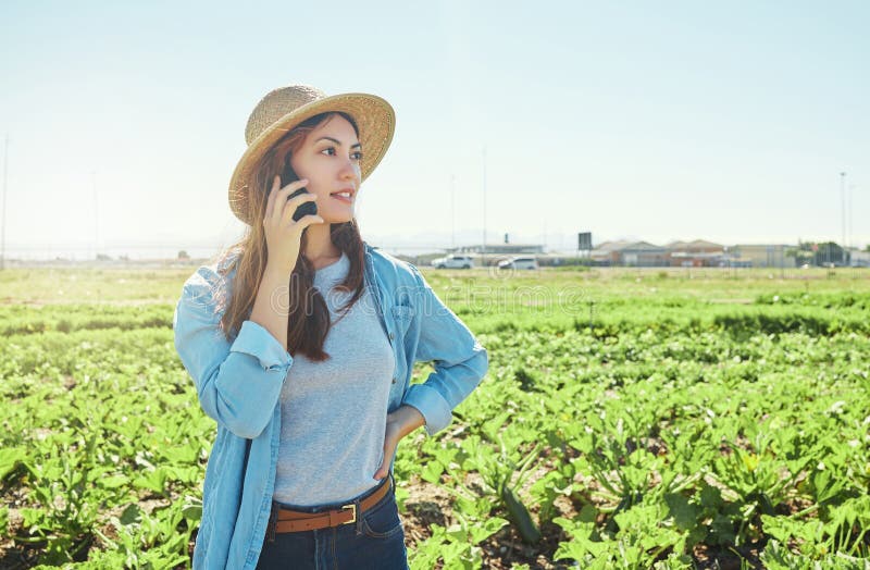 Im Ready To Start Shipping. a Young Female Farmer Using Her Phone To ...