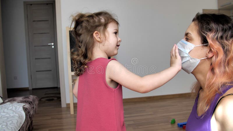 Little Serious Daughter Puts on Her Mom Medical Mask. Stay Home Mom ...