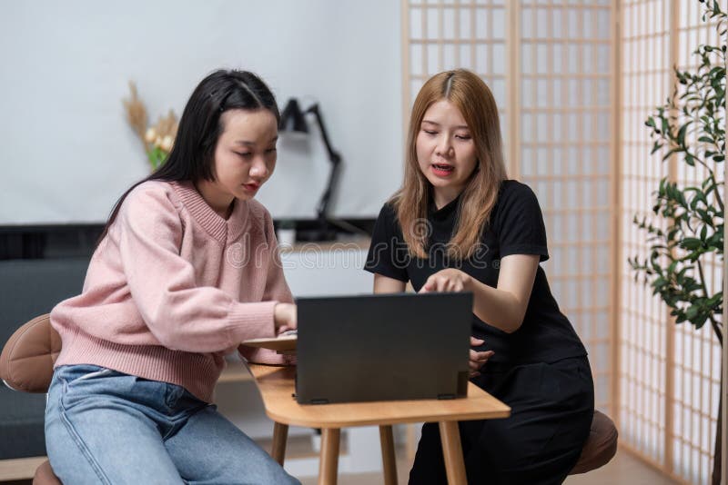 Young Female Friends Studying Online Together and Doing Homework in a ...