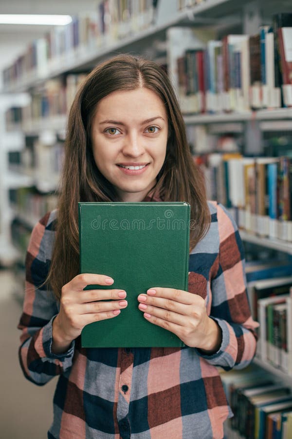 Young Female Girl Student Smiling with Book in Library Stock Image ...