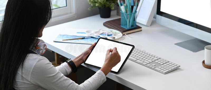A Female Graphic Designer Hand Drawing on Computer Tablet at Her ...
