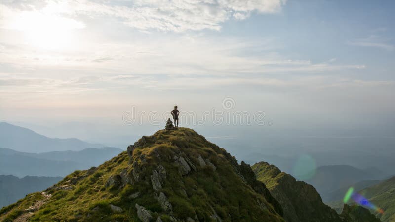 Young Female Hiker Looking Over the Valley from the Top of the Mountain ...