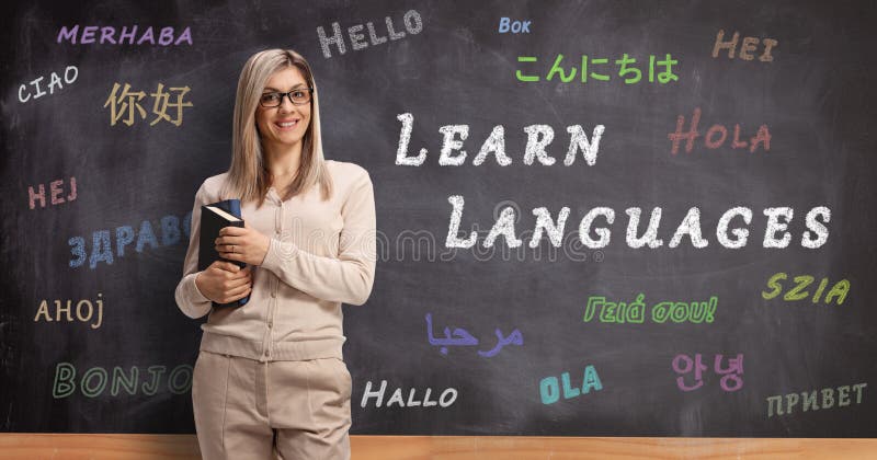 Young Female Language Teacher Standing in Front of a Blackboard with ...