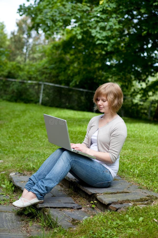 Young female with laptop stock photo. Image of woman - 15077948