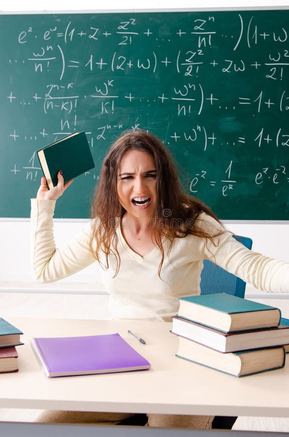 The Young Female Math Teacher in Front of Chalkboard Stock Photo ...