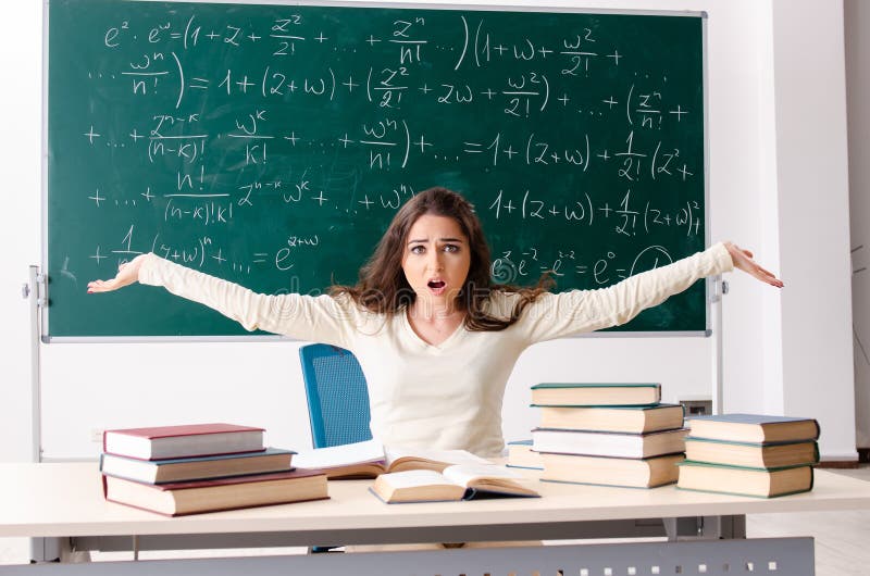 The Young Female Math Teacher in Front of Chalkboard Stock Photo ...