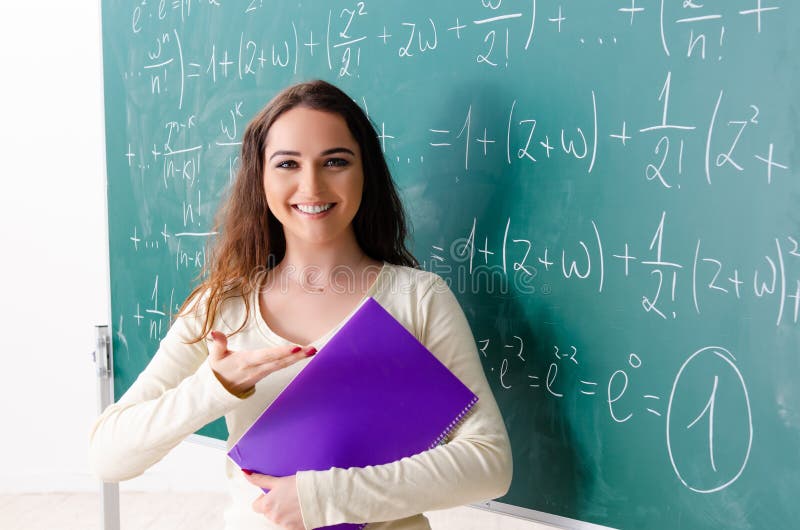 The Young Female Math Teacher in Front of Chalkboard Stock Photo ...