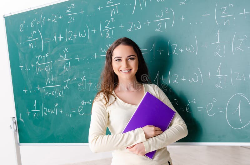 The Young Female Math Teacher in Front of Chalkboard Stock Photo ...
