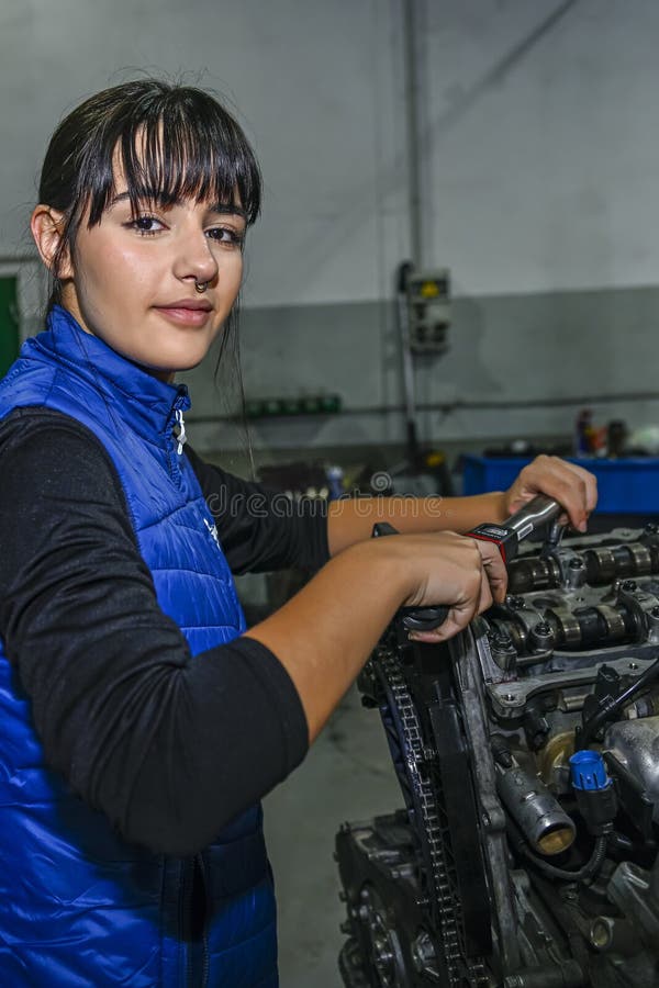 Young Female Mechanic, Working on the Repair of a Car Engine. Stock ...