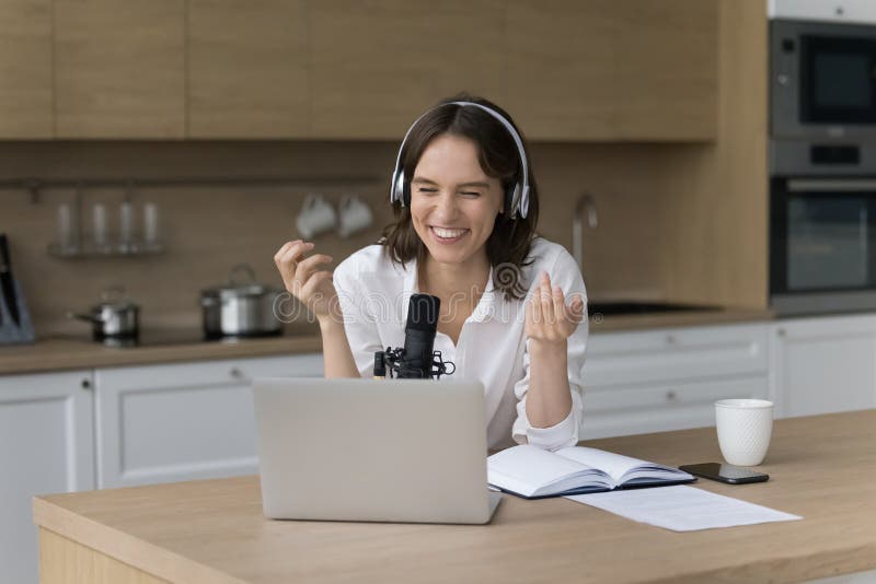 Female Podcaster Sits at Kitchen Table Speaking into Microphone Stock ...