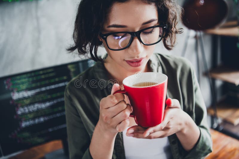 Young Female Programmer Enjoying a Break while Sipping Tea in a Casual ...