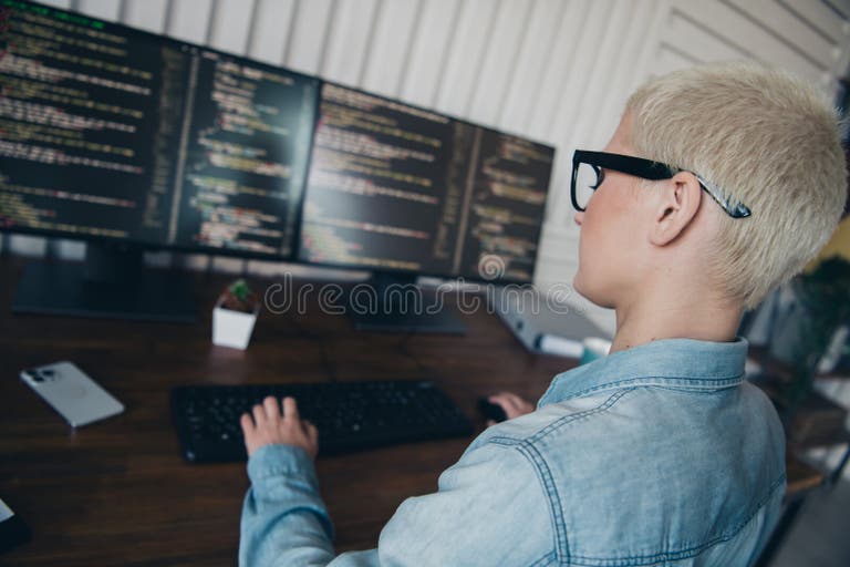 Young Female Programmer Working on Complex Coding Tasks in a Modern ...