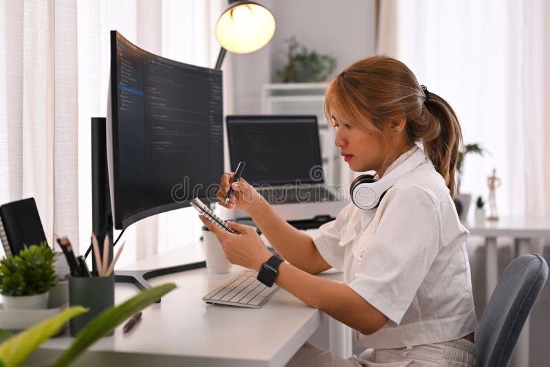 Young Female Programmer Working on Computer To Check Coding in Bugging ... Young Female Programmer Working on Computer To Check Coding in Bugging ...