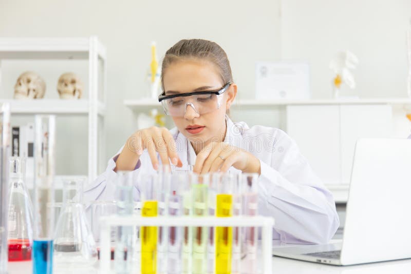 A Young Female Scientist is Operating in a Science Lab with Various ...