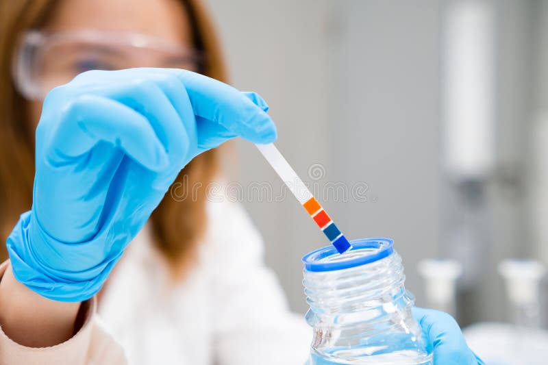 Young Female Scientist Measures PH of the Solution Using Indicator ...