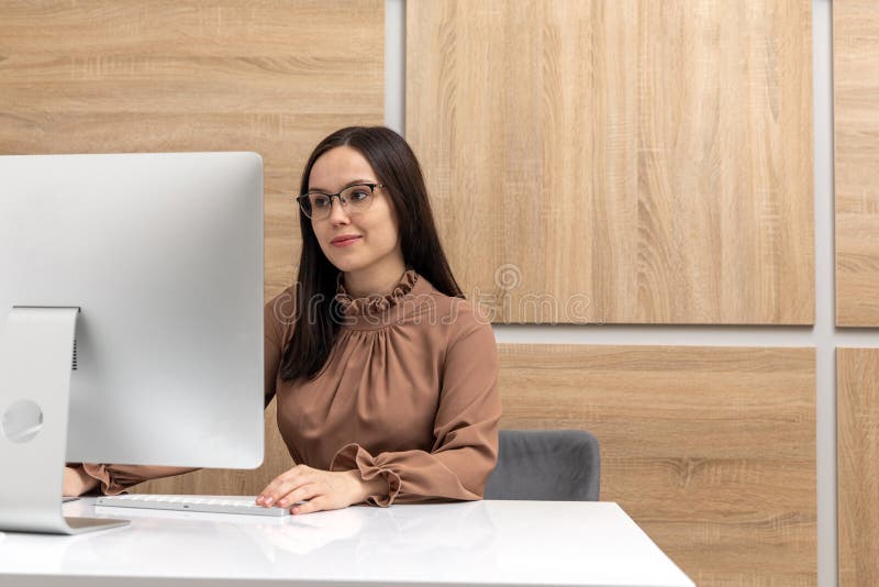 Young Female Secretary Working in Office on Computer Stock Photo ...