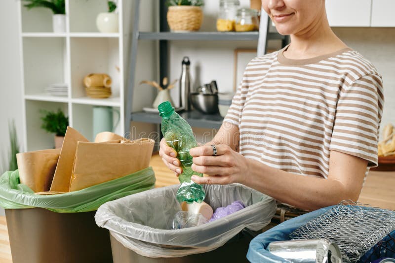 Young Female Smashing Plastic Bottle Over Trash Bin Stock Photo - Image ...