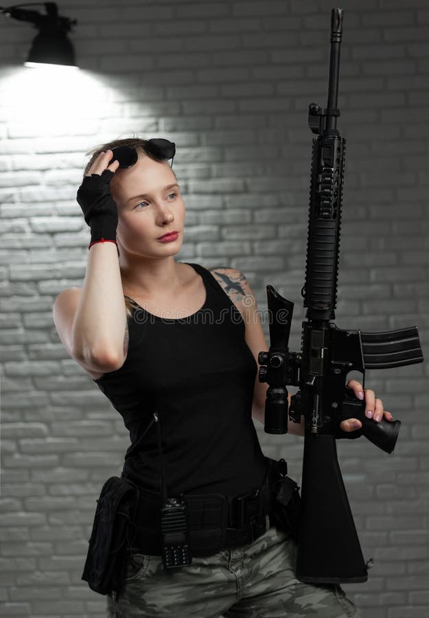 A Young Female Soldier Poses with an Automatic Rifle with a Telescopic ...