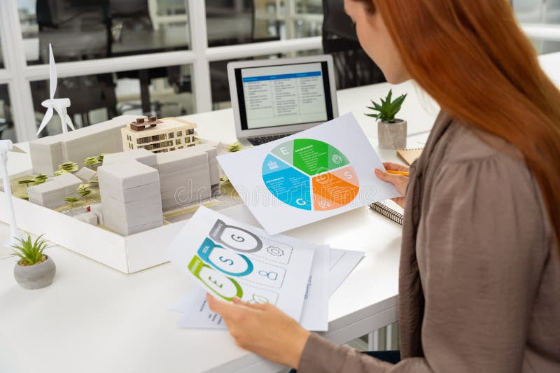 Young Female Specialist Scrutinizing the Diagrams of a New Project ...