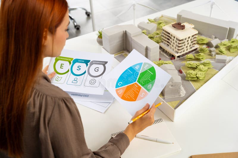 Young Female Specialist Scrutinizing the Diagrams of a New Project ...