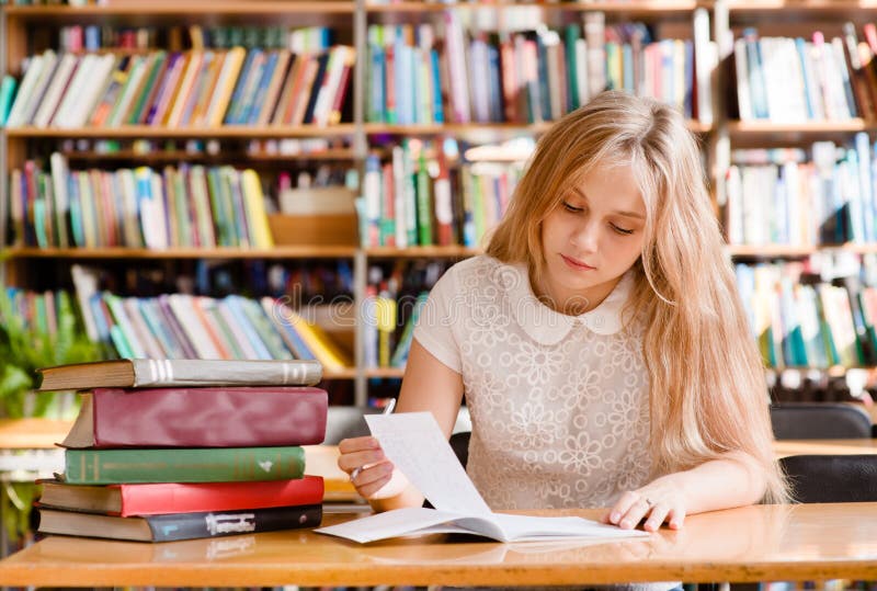Young Female Student Doing Assignments in Library Stock Photo - Image ...