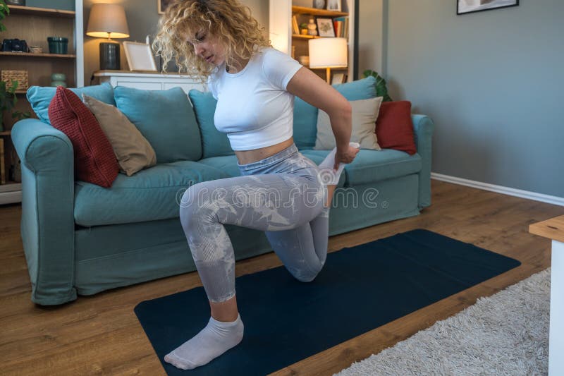 Young Female Student Exercising at Home To Relieve Back Pain from Long ...
