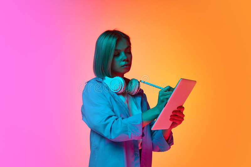 Portrait of Young Female Student Using Tablet Isolated Over Gradient ...