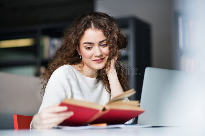 Young Female Student in Reading Library, Searching Information for ...