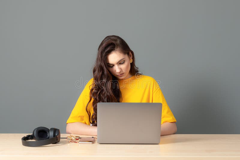 Young Female Student Sitting at the Table, Using Laptop when Studying ...