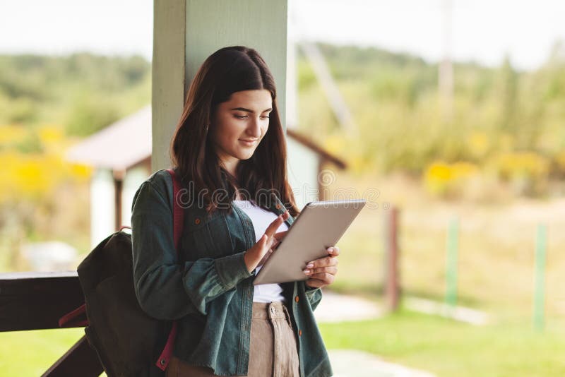 Young Female Student Studying Using Tablet in College or Private School ...