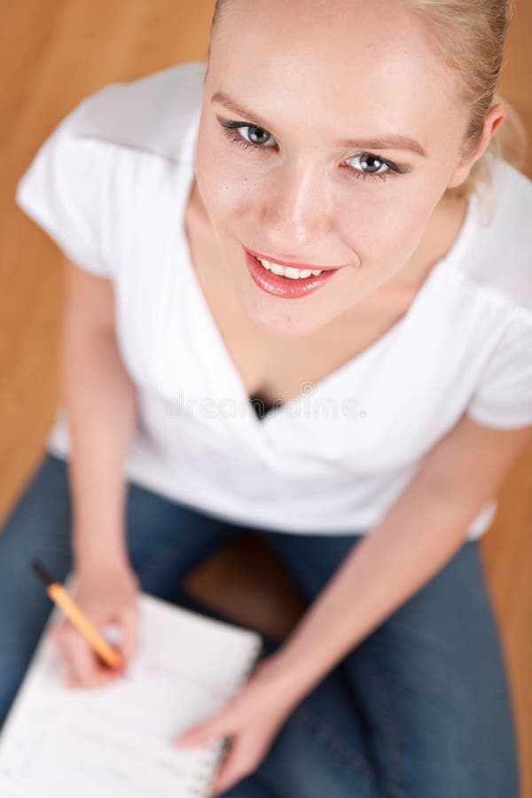 Young Female Student Taking Notes while Studying Stock Image - Image of ...