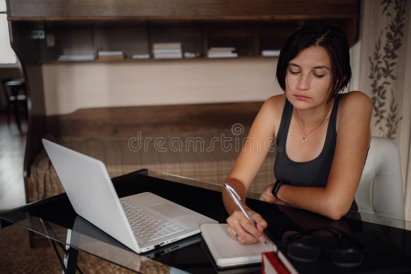 Young Female Student Using Laptop, Communicates on Internet with ...