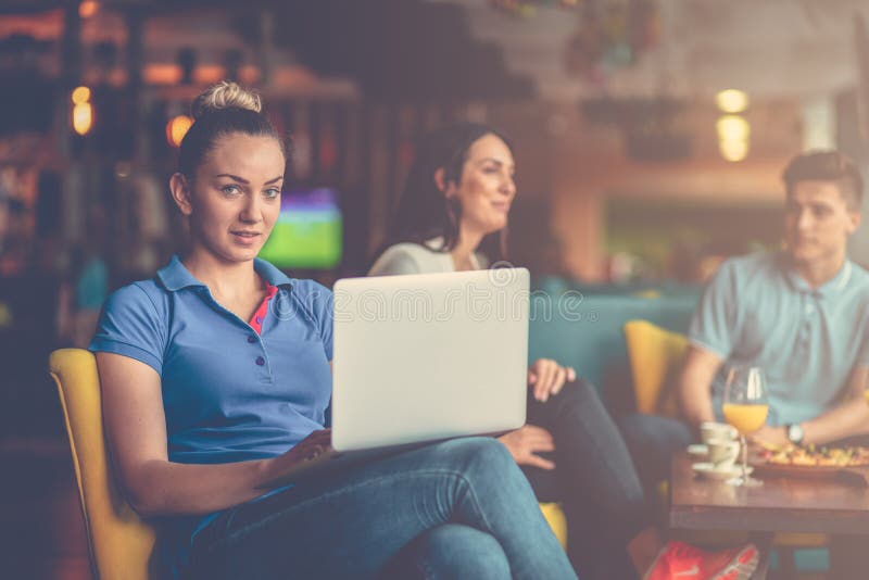 Young Female Student is Using Laptop Computer in Cafe Stock Photo ...