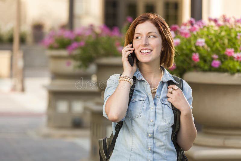 Young Female Student Walking Outside Using Cell Phone Stock Image ...