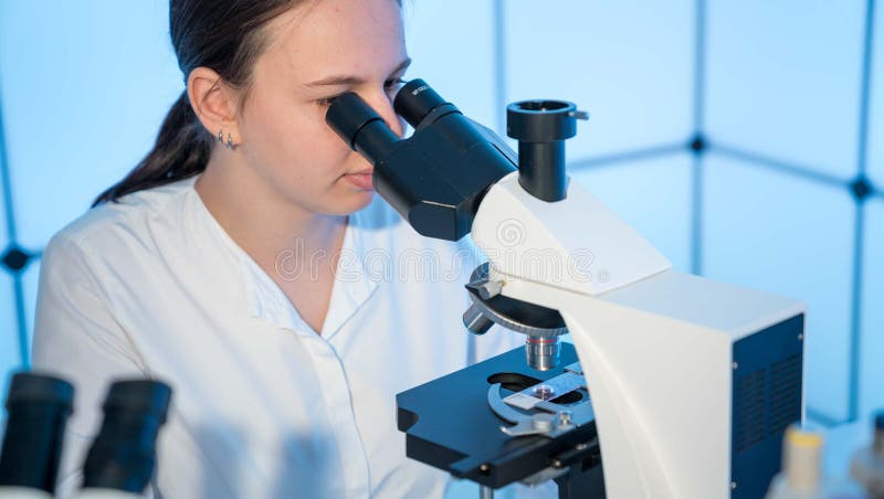 Young Female Student Working in a Microbiology Laboratory with a ...