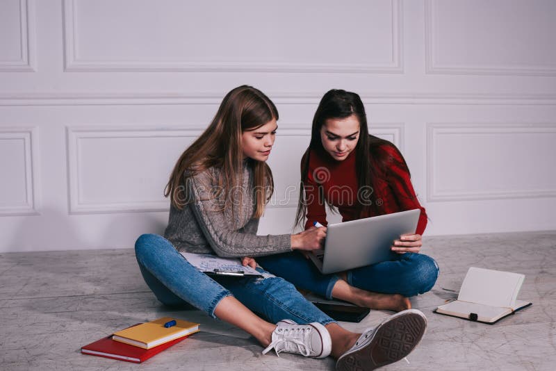 Young Students Studying Together Using Laptop and Taking Notes Stock ...