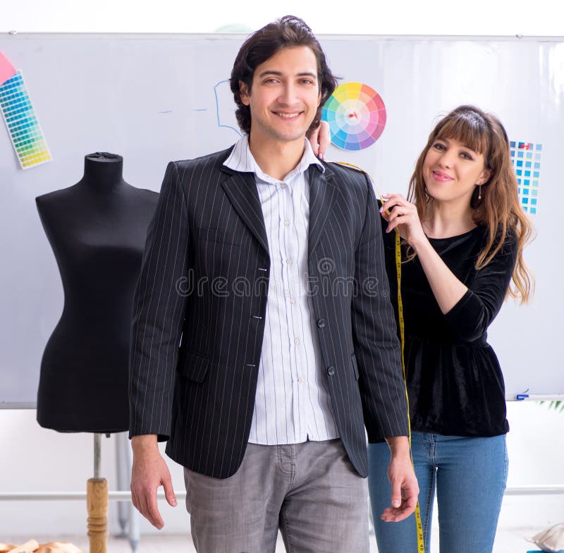 Young Female Tailor Taking Measurements for Formal Suit Stock Photo ...