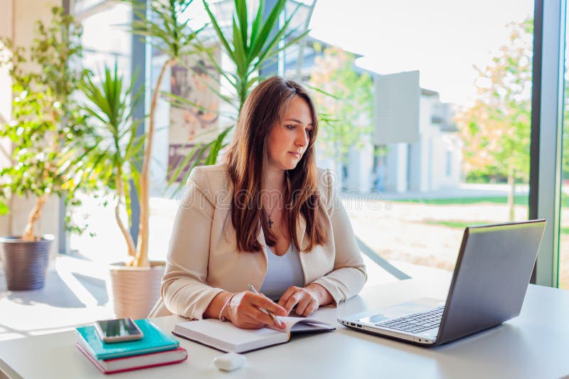 Young Female Teacher Getting Ready for Lesson Working in Office Using ...